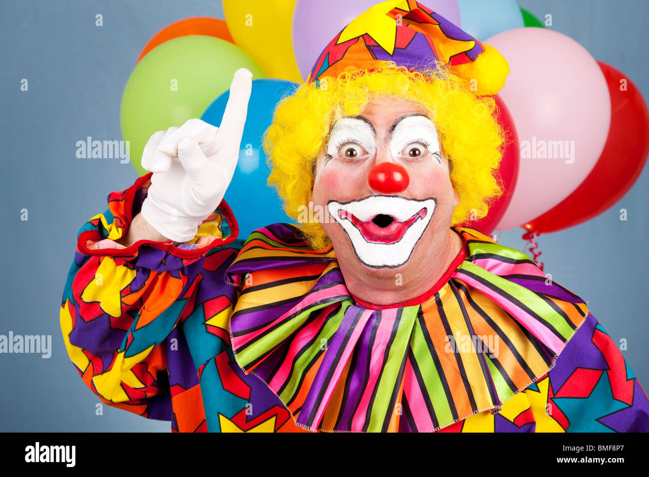 Funny circus clown with a bright idea Stock Photo - Alamy