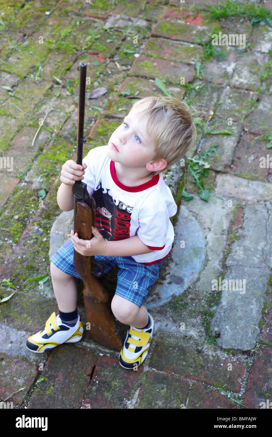 Child blond boy playing with air gun Stock Photo - Alamy