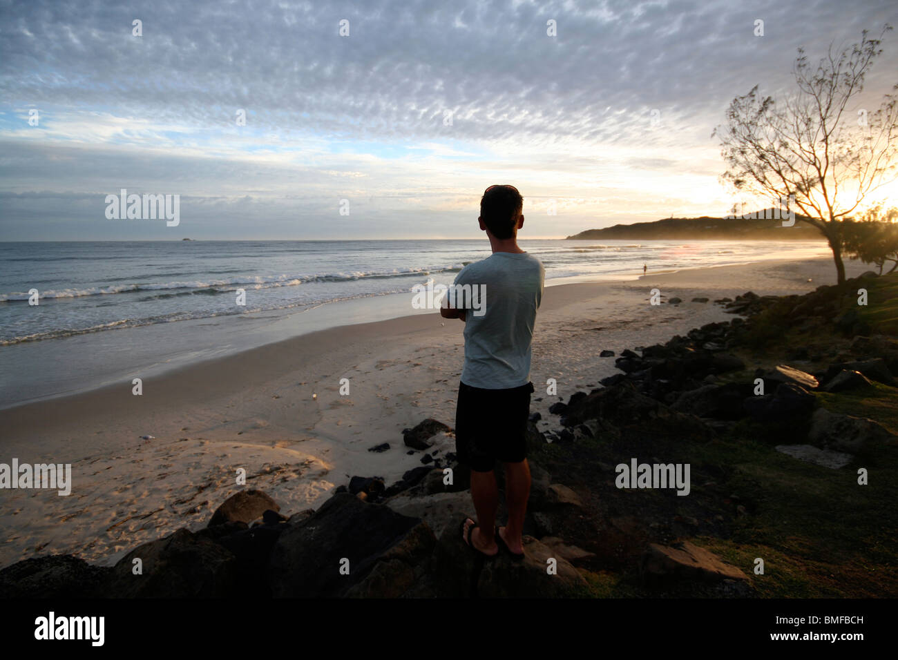 Man looking across the beach at dawn, Byron Bay, Australia Stock Photo ...