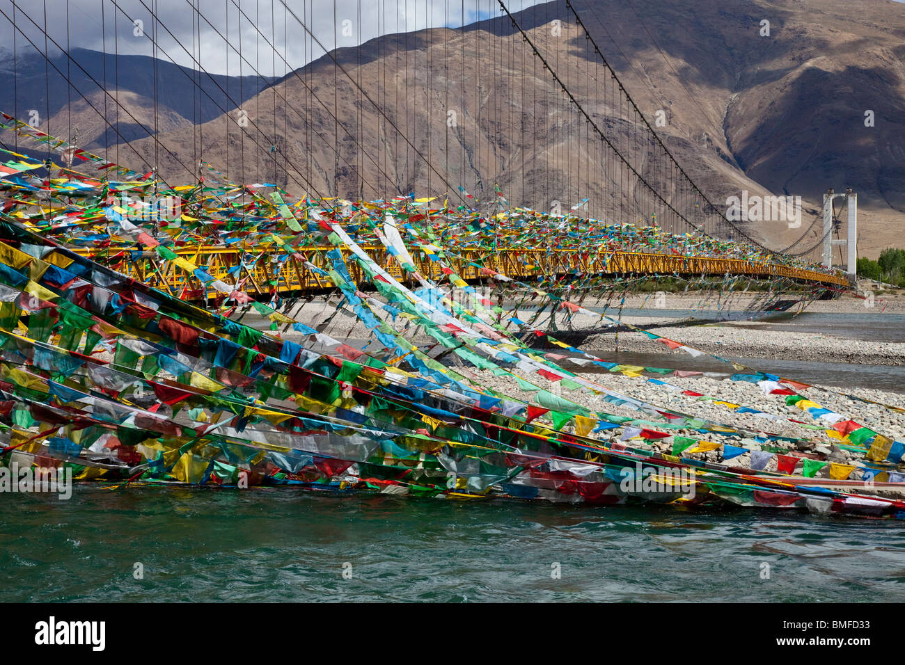 Prayer flags on a bridge over the Lhasa or Kyi-Chu River near Lhasa ...