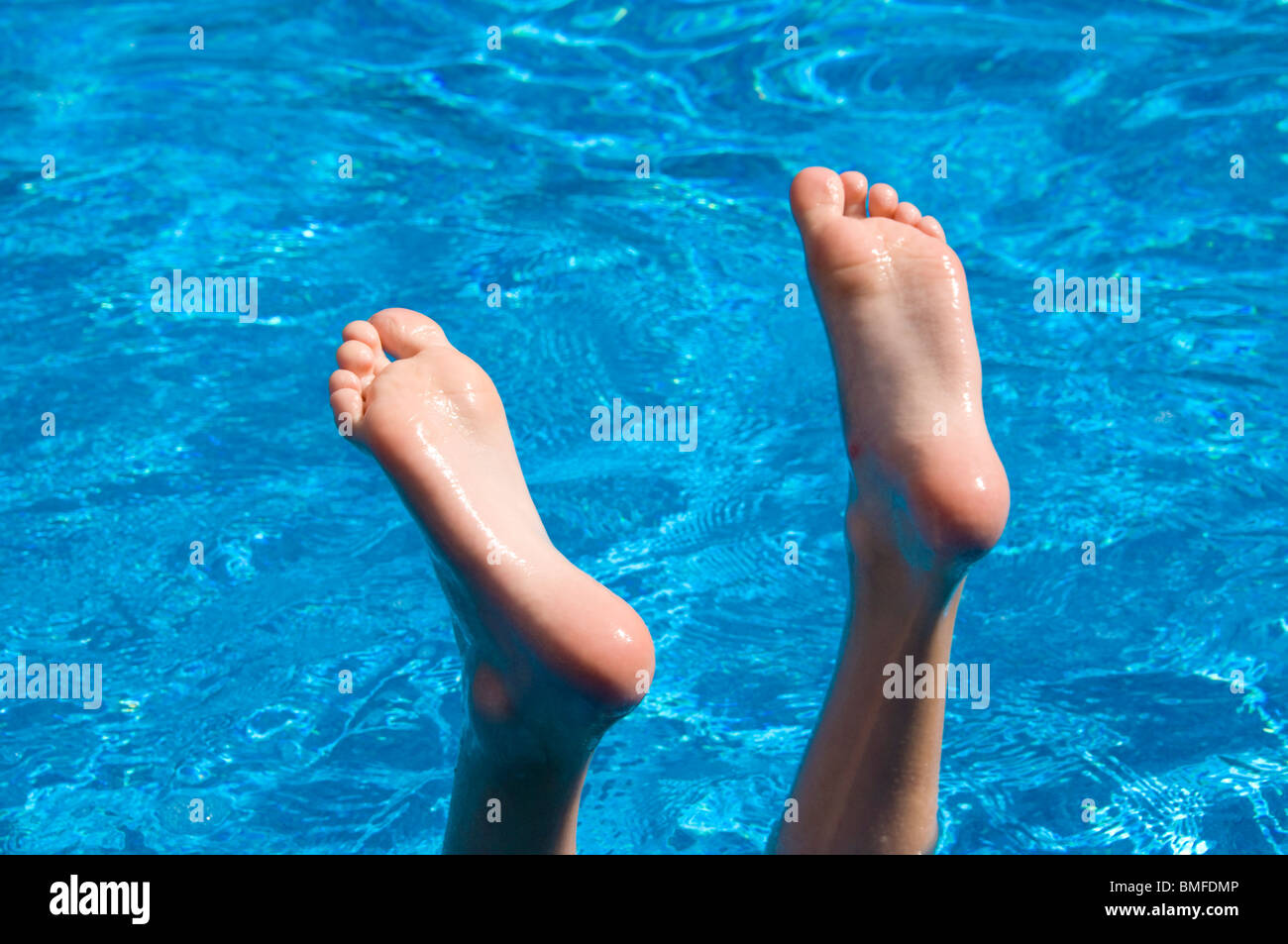 Feet in the water Stock Photo - Alamy