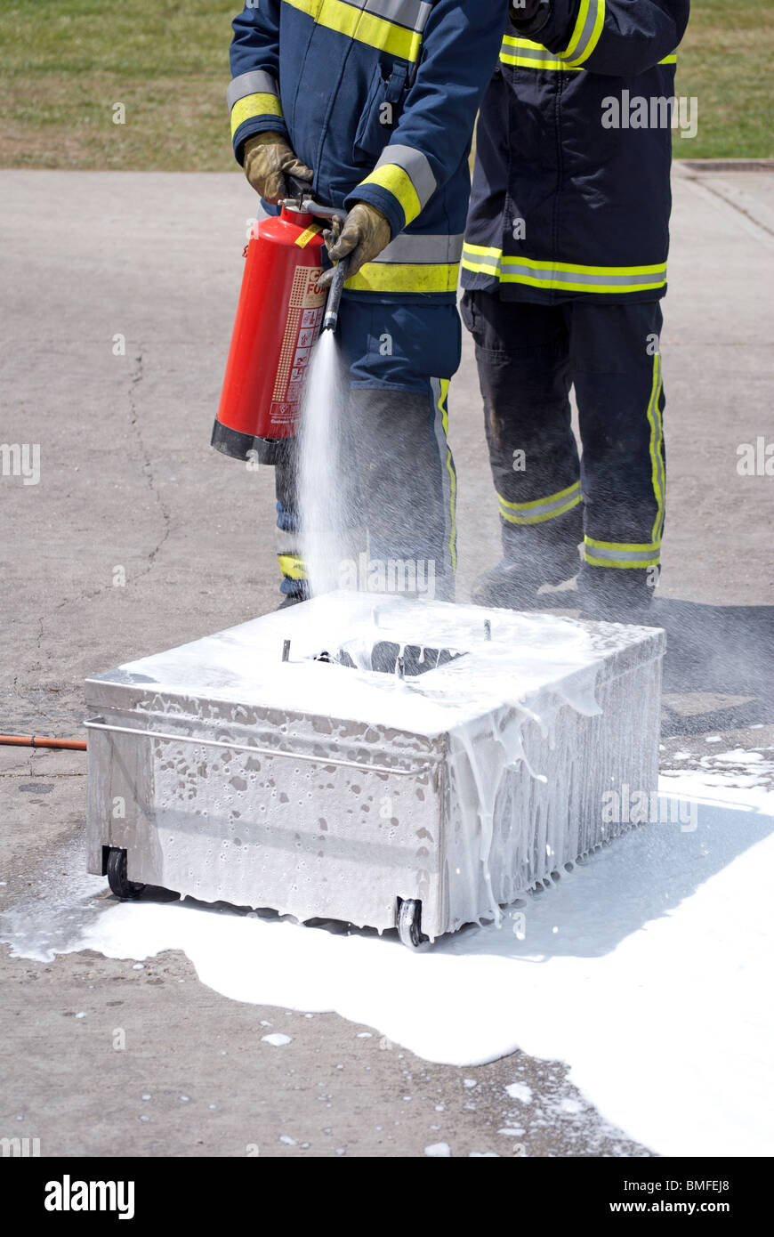 Simulated training putting out a fire with an extinguisher Stock Photo ...