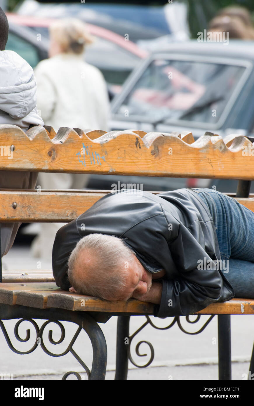 Homeless man sleeping on bench hi-res stock photography and images - Alamy