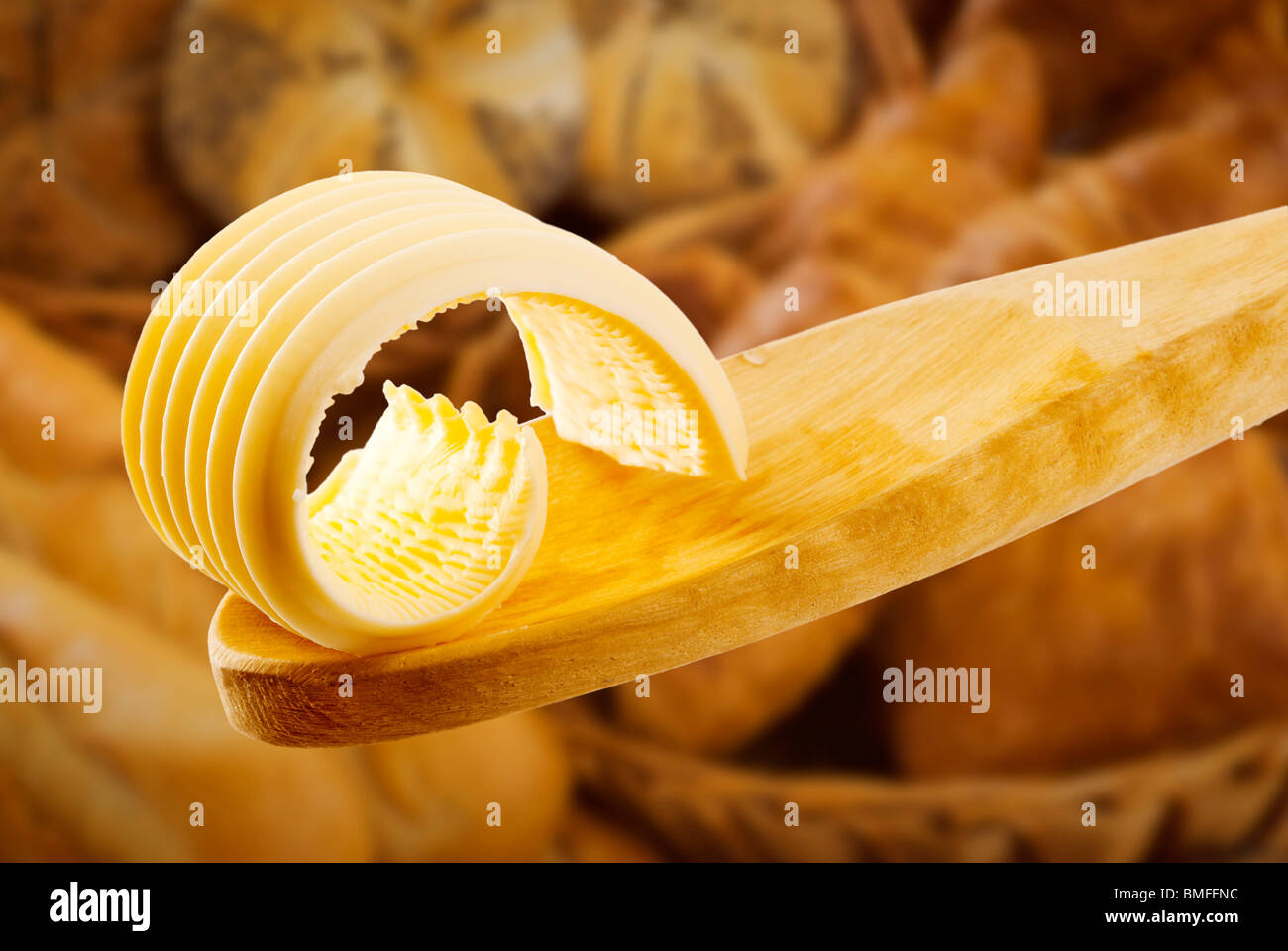 Butter curl on a wooden spoon Stock Photo - Alamy