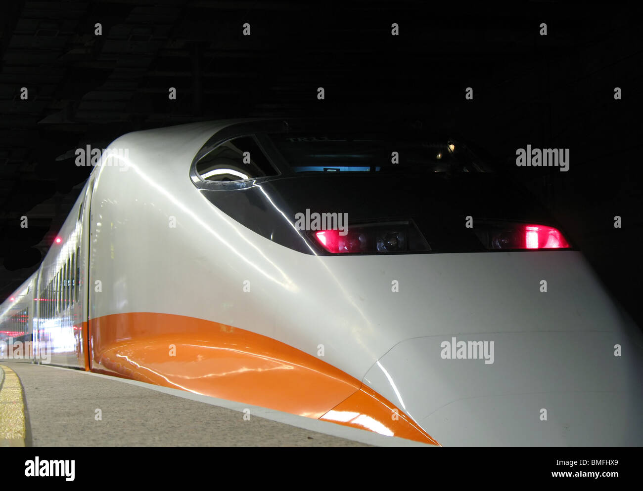 A sleek modern train pulled into a station Stock Photo - Alamy