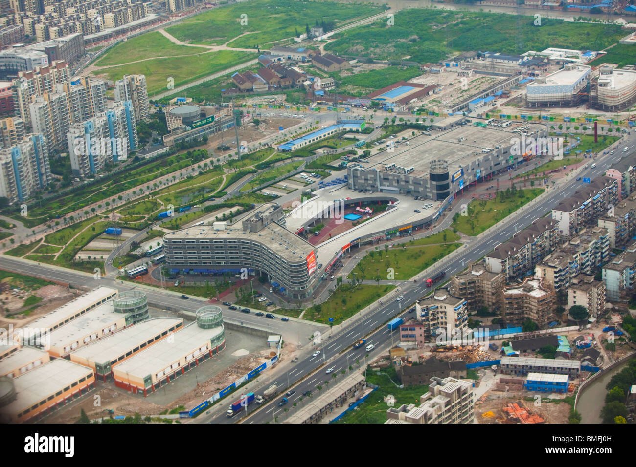 Aerial view of large shopping mall erected among residential complexes ...