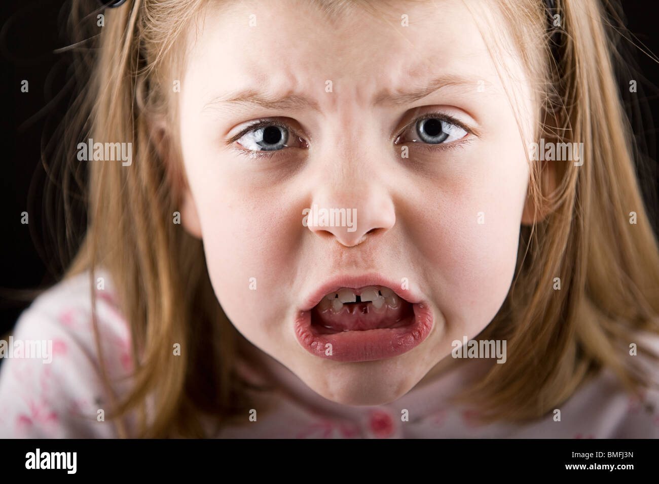 Shot of an Upset Child with Gaps in her Teeth Stock Photo - Alamy