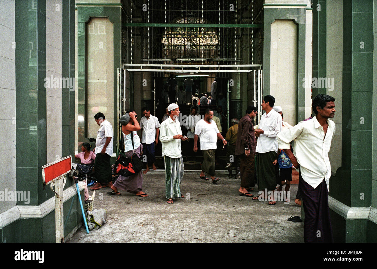 Muslim men leave a mosque after Friday prayers in Yangon, May 2010 ...