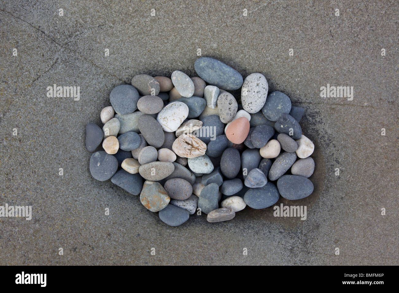 Pebbles in a dry rock pool Stock Photo - Alamy