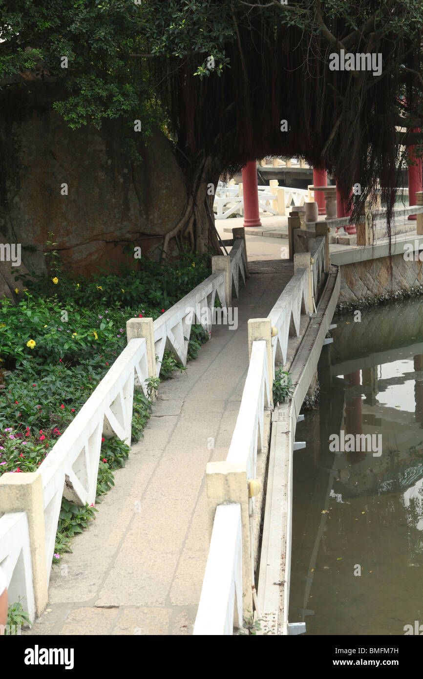 View of narrow path along pond in Sea Garden, Shu Zhuang Garden ...