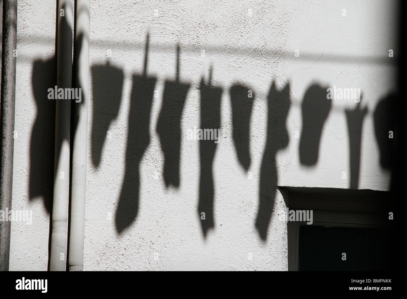 shadow of socks hanging on washing line in sun Stock Photo - Alamy