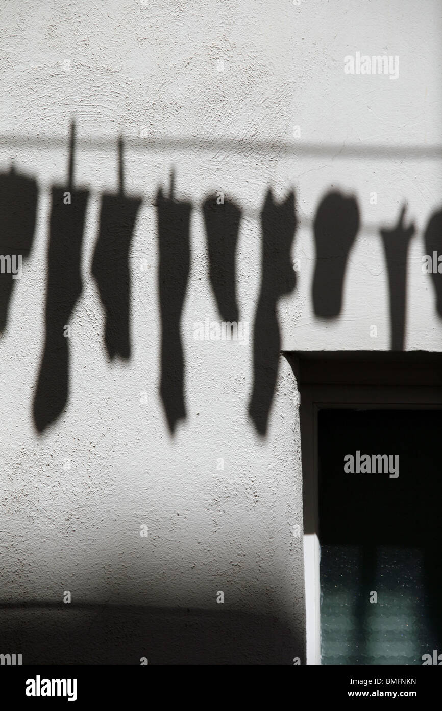 shadow of socks hanging on washing line in sun Stock Photo - Alamy