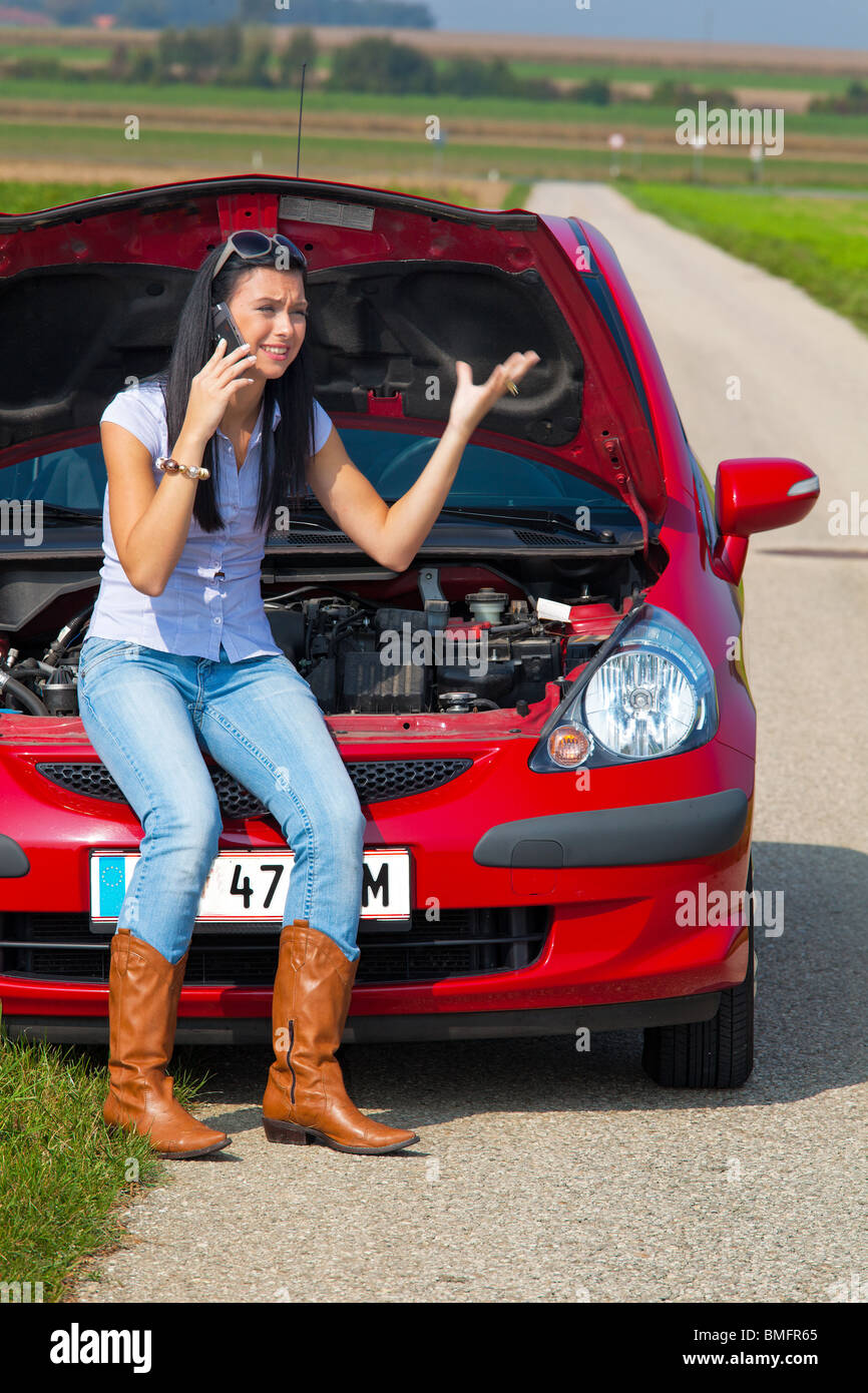 Young woman with her car breakdown. Engine failure Stock Photo - Alamy