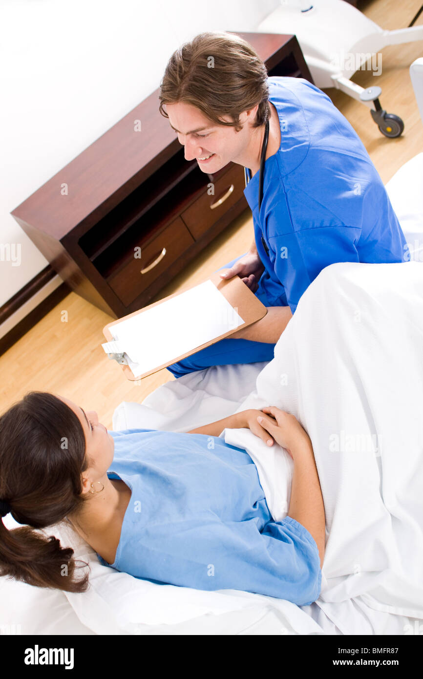male doctor or nurse visiting patient in hospital ward Stock Photo - Alamy