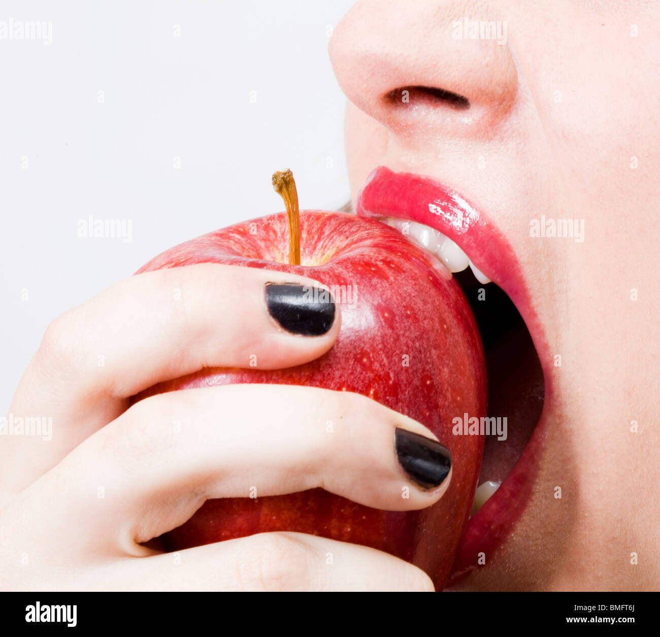 a young pretty girl eating a fresh healthy red apple Stock Photo - Alamy