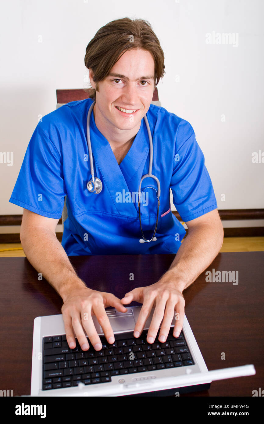 male doctor working on laptop computer Stock Photo - Alamy