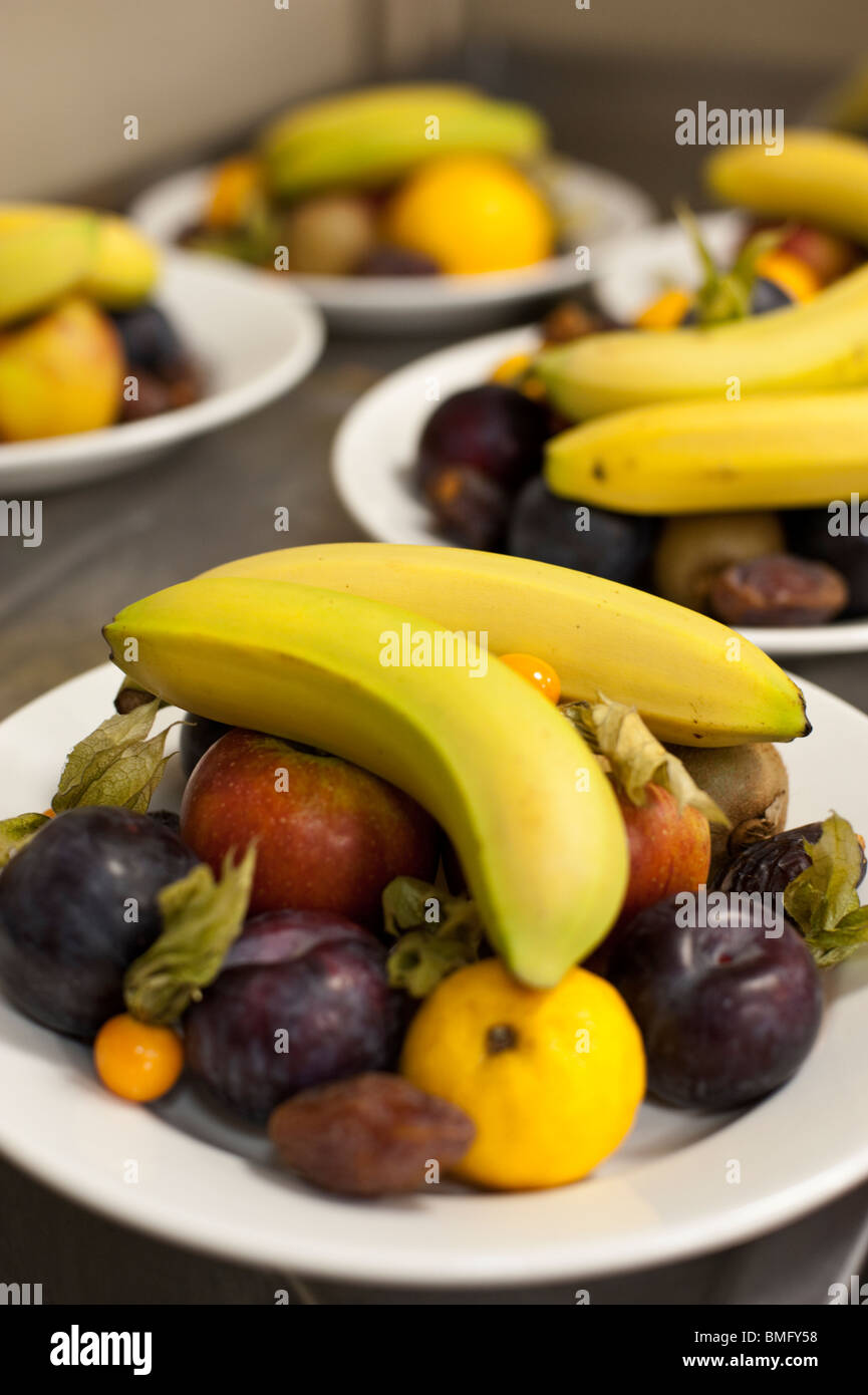 Plates of mixed fruits served as the "dessert" course of a formal ...