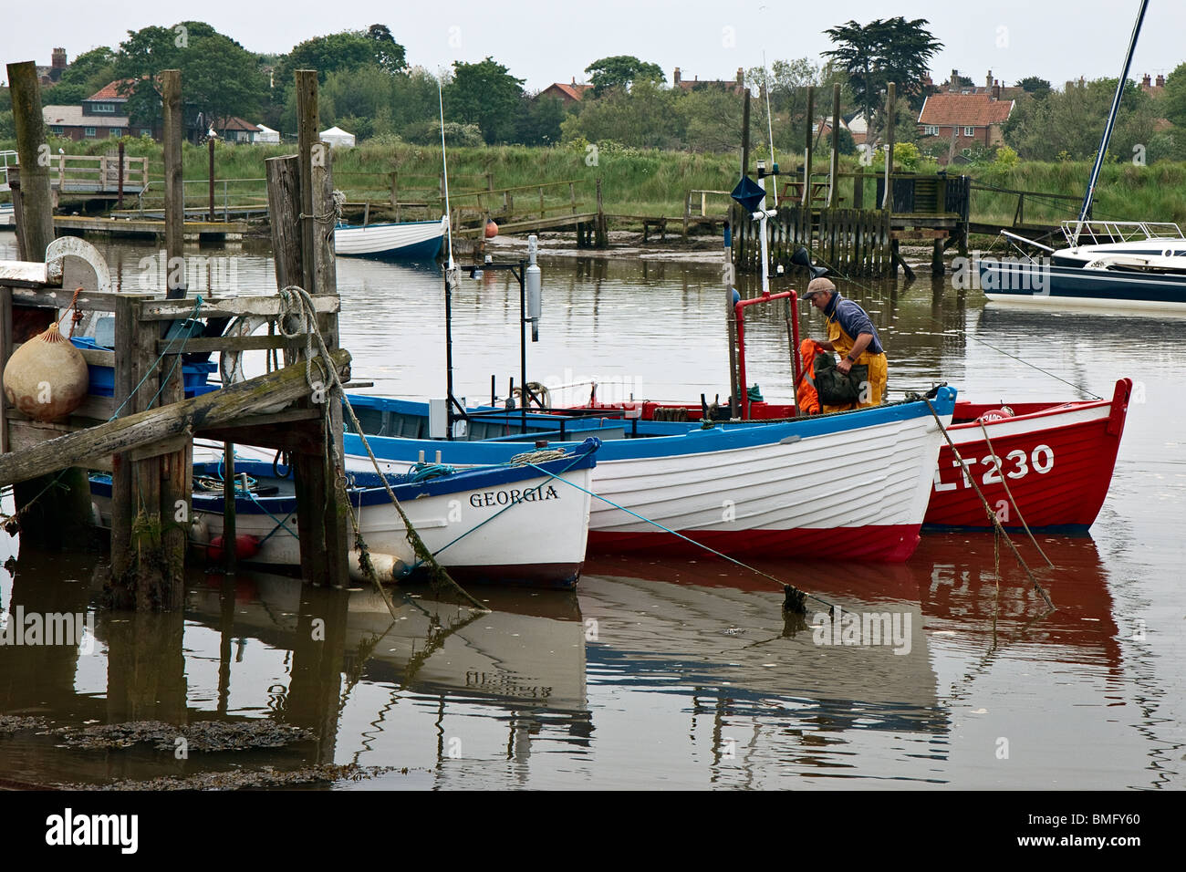 Row of fishing boats hi-res stock photography and images - Alamy