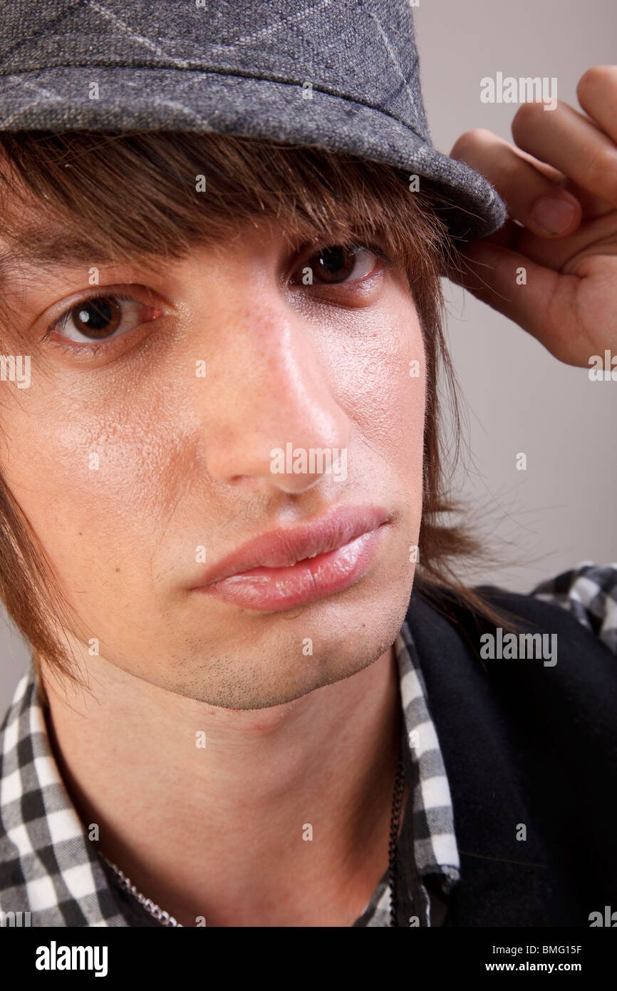 young man with checked shirt and hat Stock Photo - Alamy