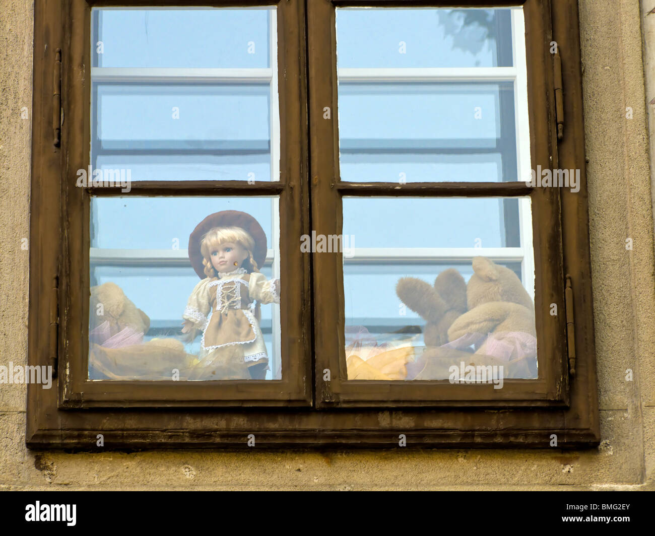 A doll and toy in a window Stock Photo - Alamy