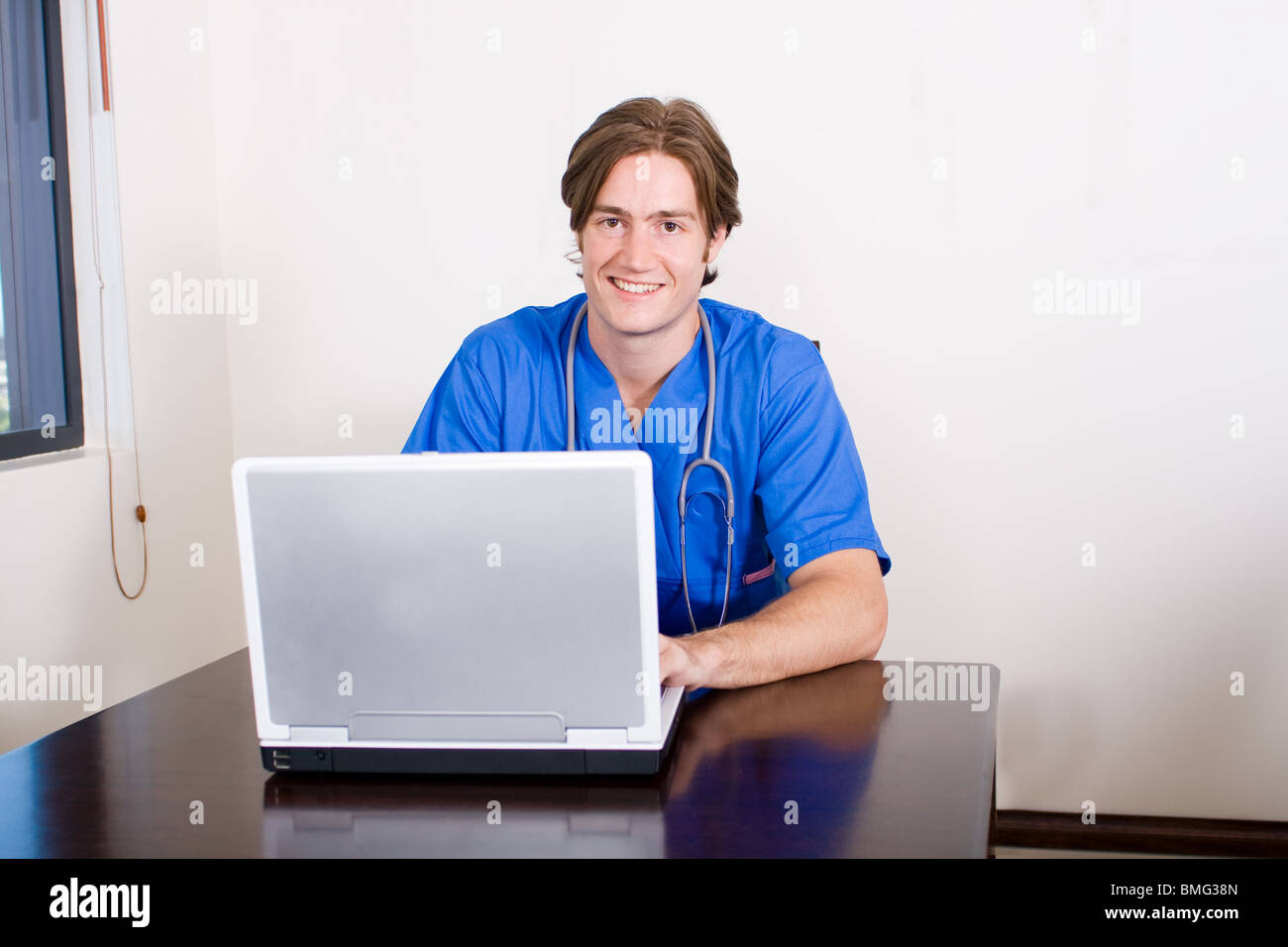 male doctor working on laptop computer Stock Photo - Alamy