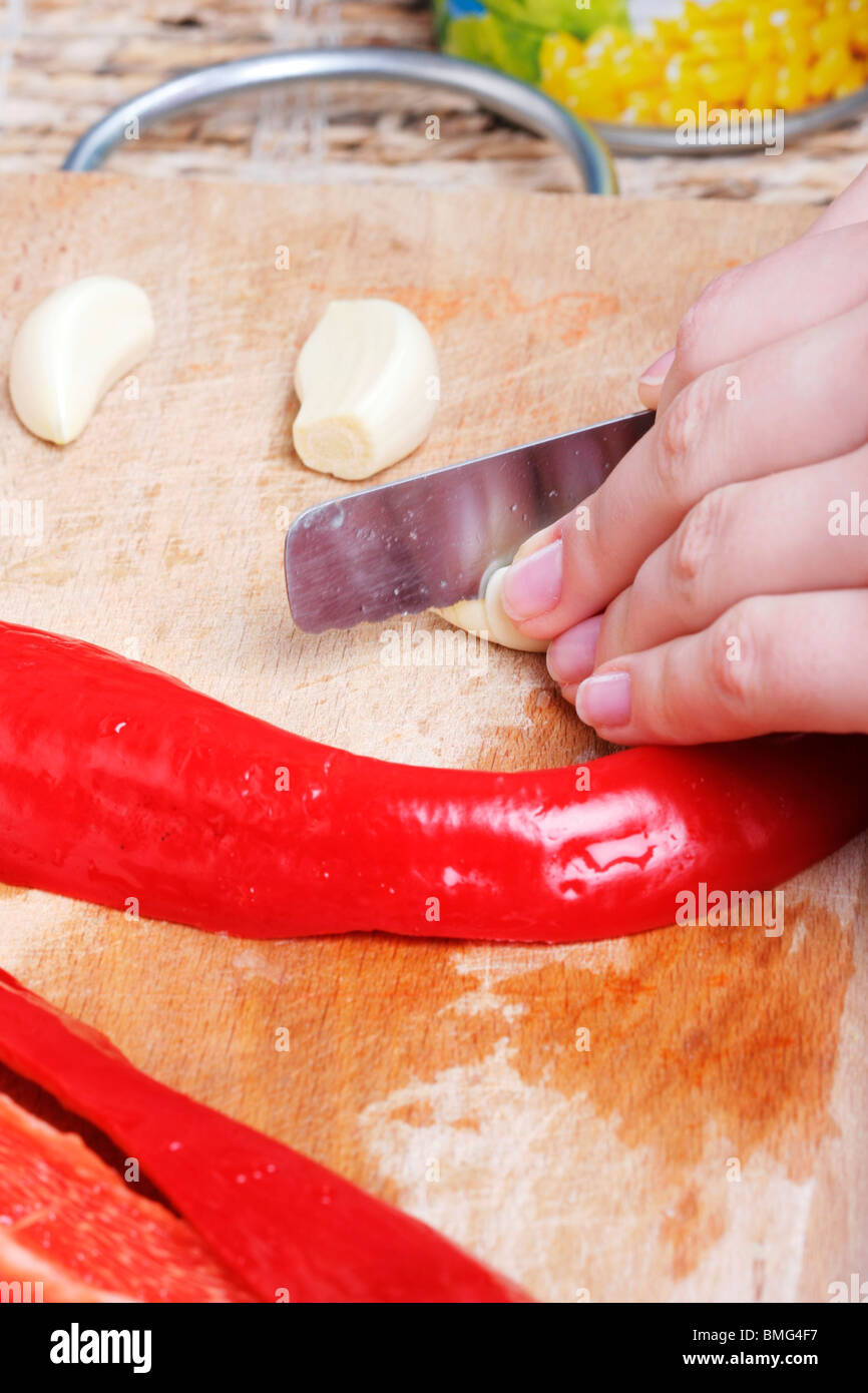 Chopping pepper with knife in small pieces Stock Photo - Alamy