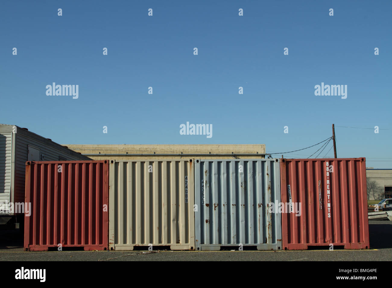 Four containers on a shipping dock Stock Photo - Alamy