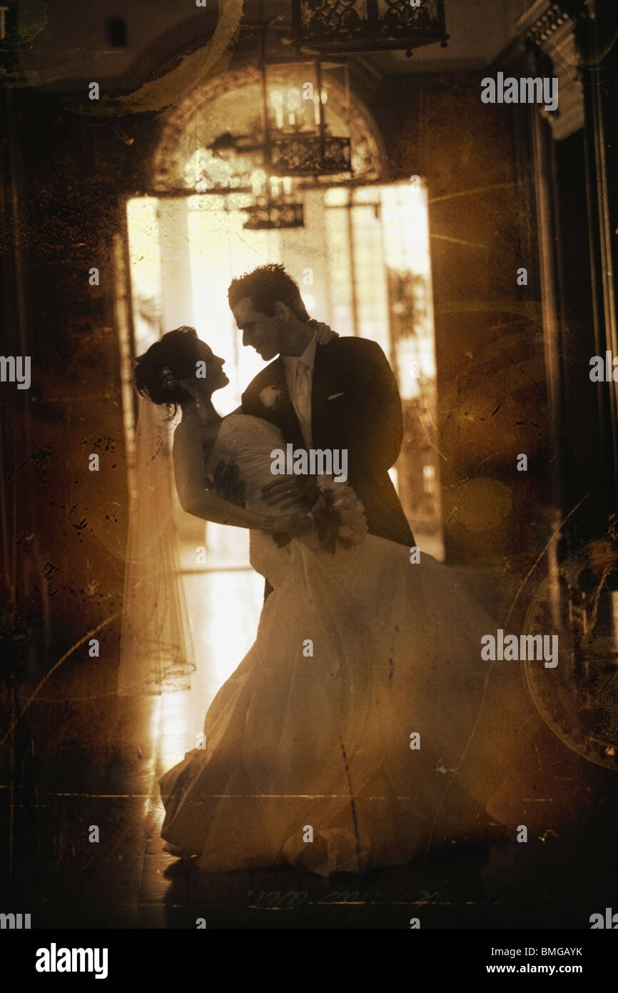 A Groom Holding His Bride Stock Photo - Alamy