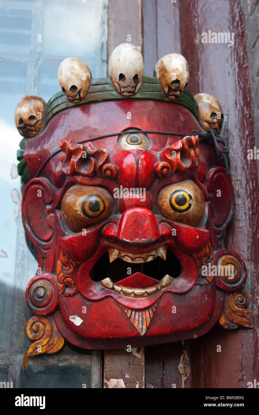 Mask hanging at the gate of a Himalayan handicrafts store, Yandai ...