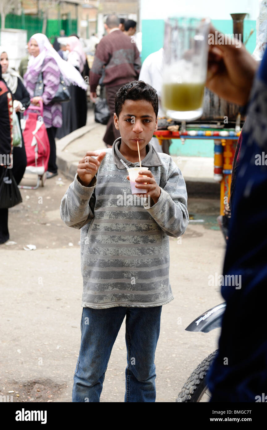 young boy drinking sugar cane juice,souk goma (friday market), street ...