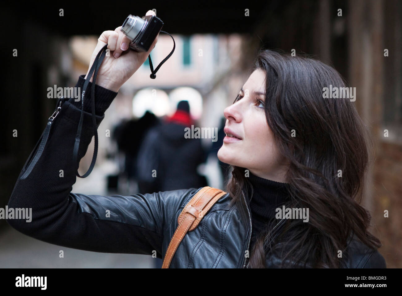A young woman taking photos on her digital compact camera Stock Photo ...