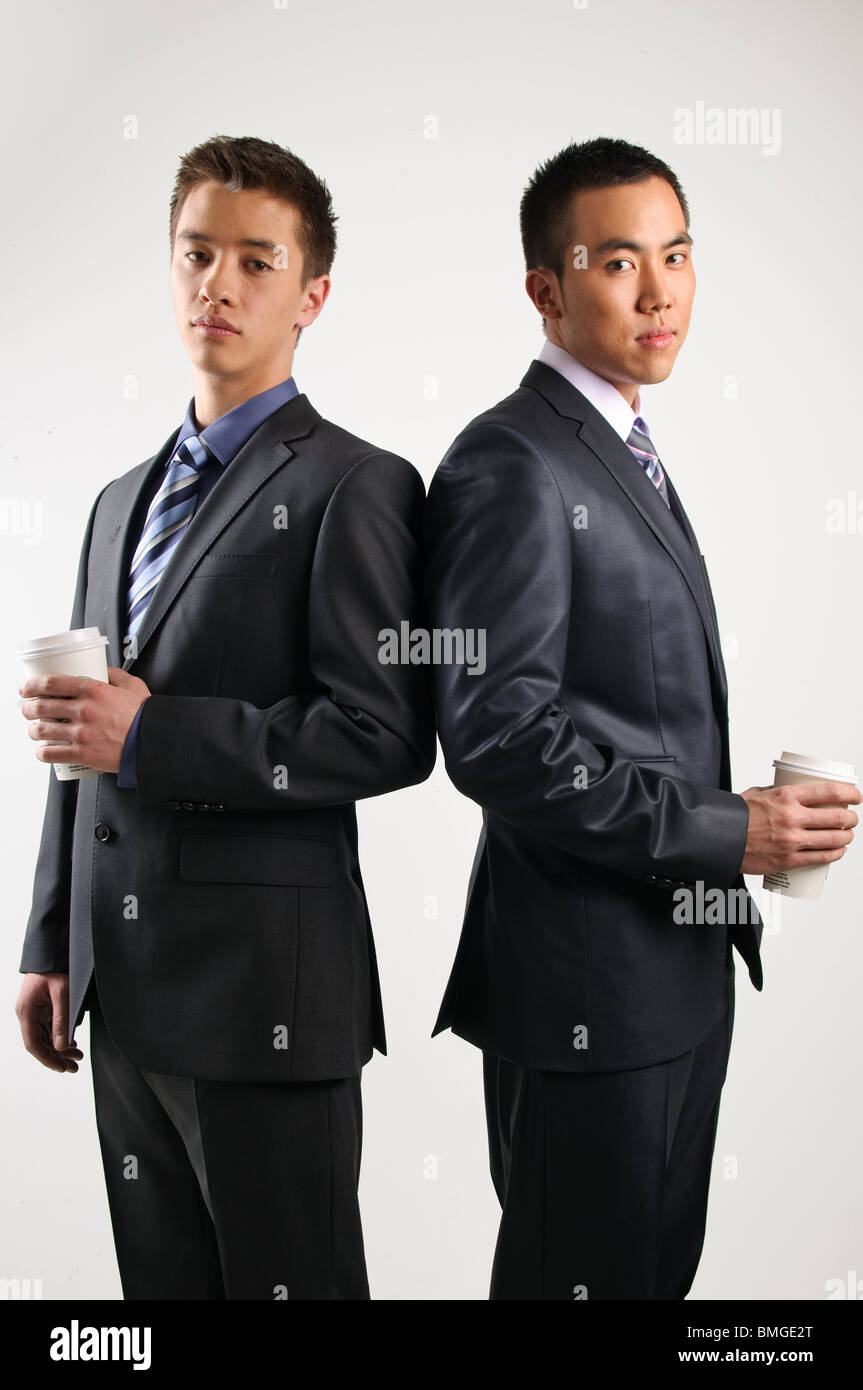 Two Men Standing Back To Back