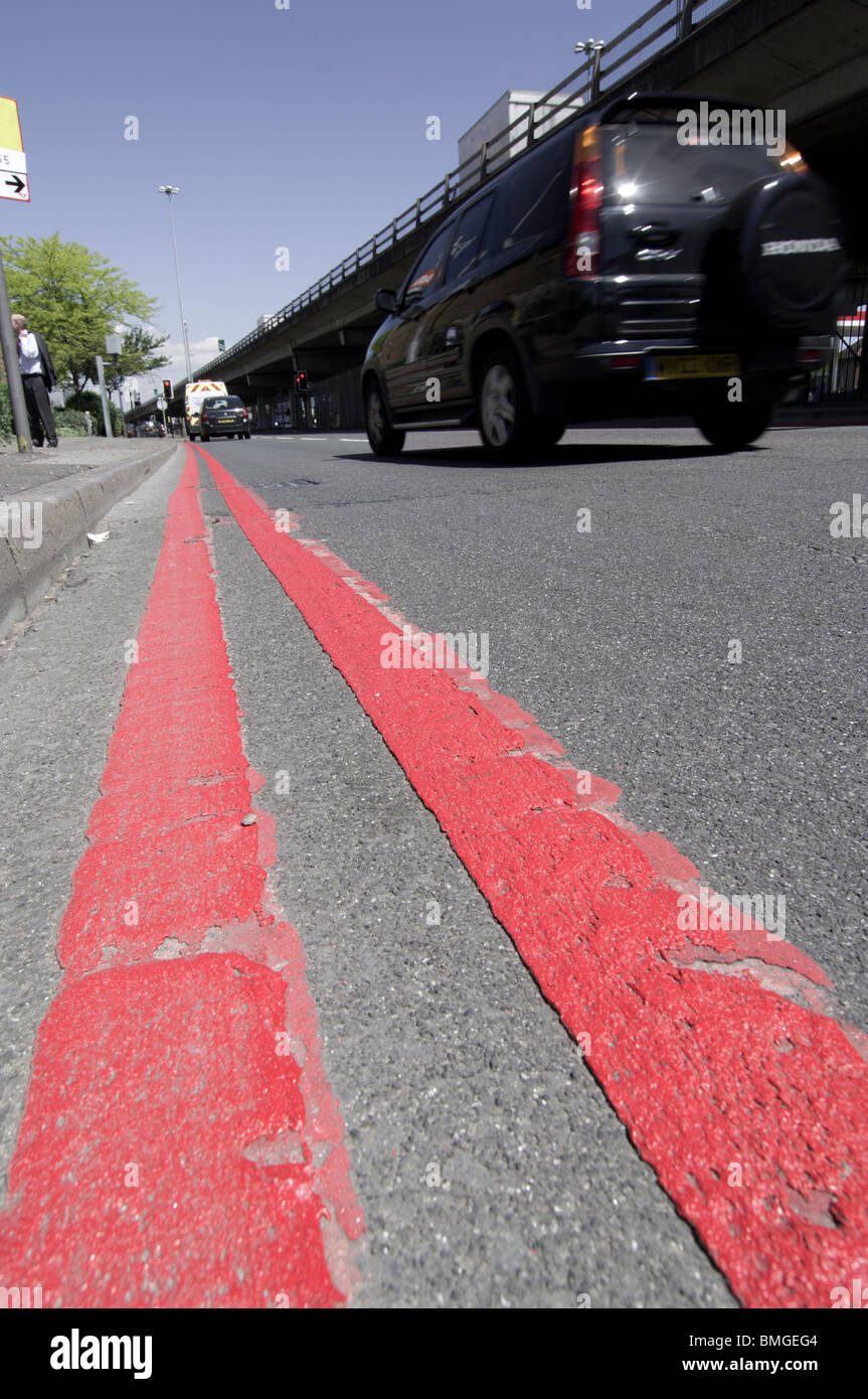 Closeup of red lines on red route no parking rush hour route Stock ...