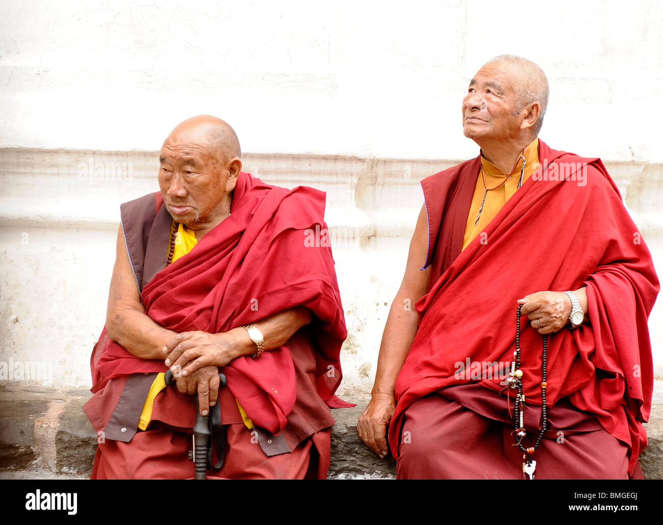 two monks resting , sitting on the steps of pratapura temple ...