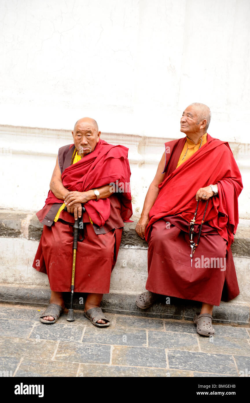 two monks resting , sitting on the steps of pratapura temple ...