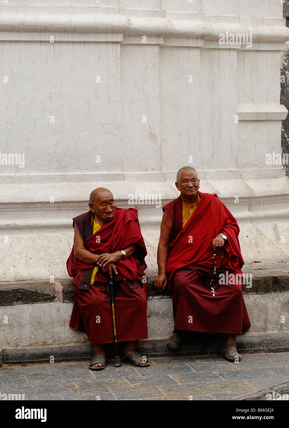 two monks resting , sitting on the steps of pratapura temple ...
