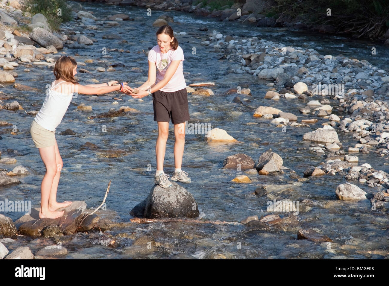 Two children playing on rocks hi-res stock photography and images - Alamy
