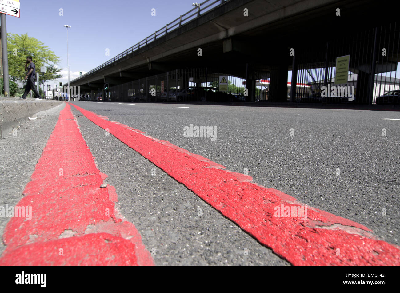 Closeup of red lines on red route no parking rush hour route Stock ...
