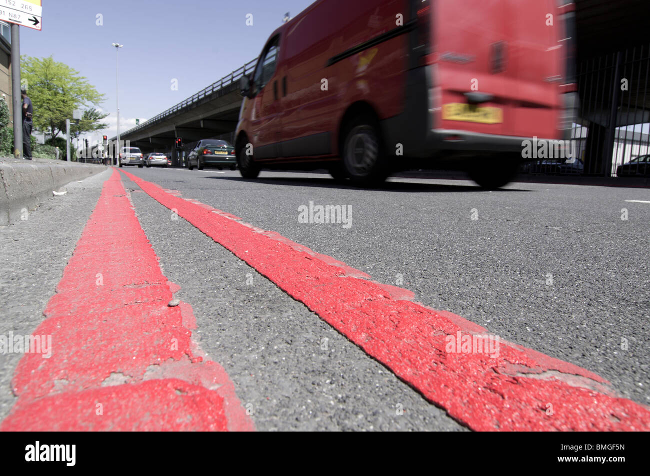 Closeup of red lines on red route no parking rush hour route Stock ...