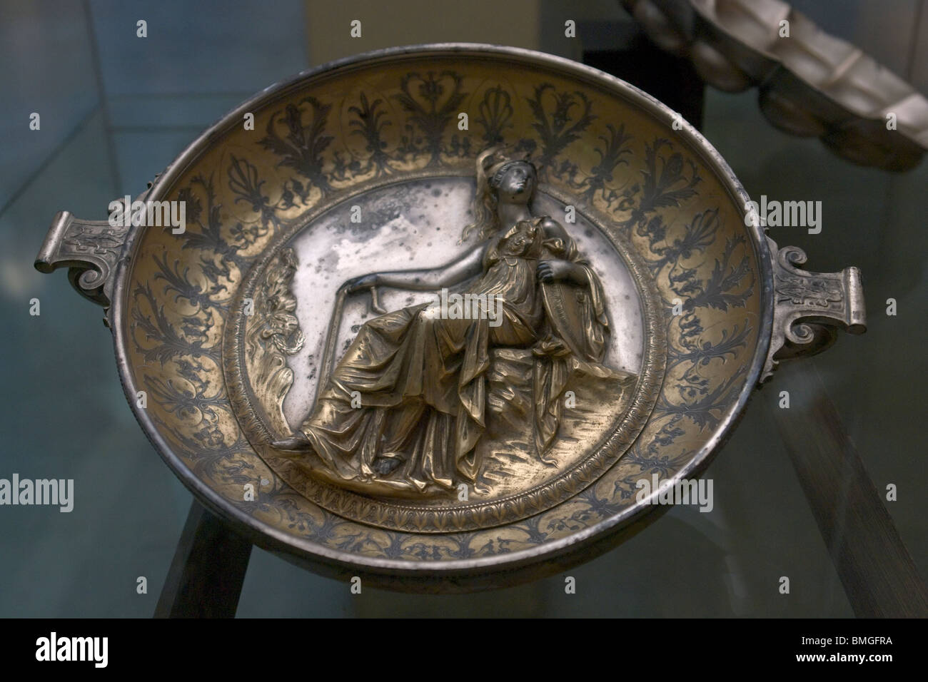 Roman cup with an embossed representation of Athena sitting in throne ...