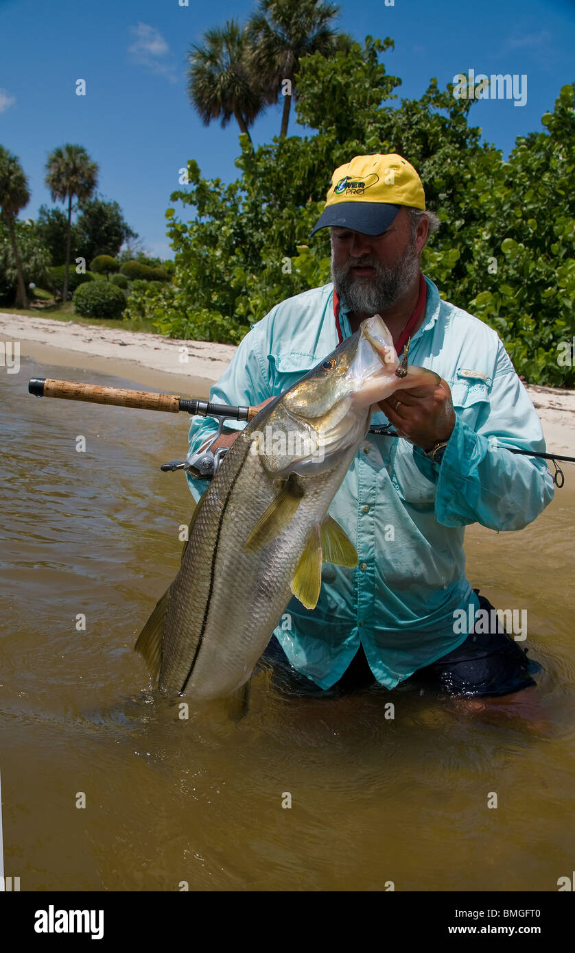 An inshore angler hefts a giant snook caught in Florida's Intracoastal ...