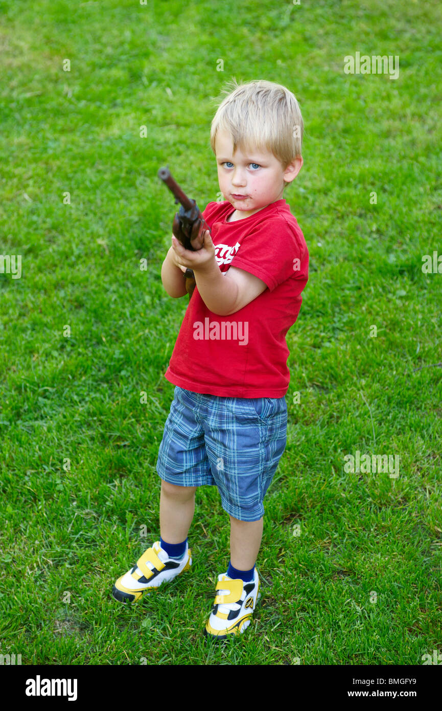 Child blond boy playing with air gun Stock Photo - Alamy