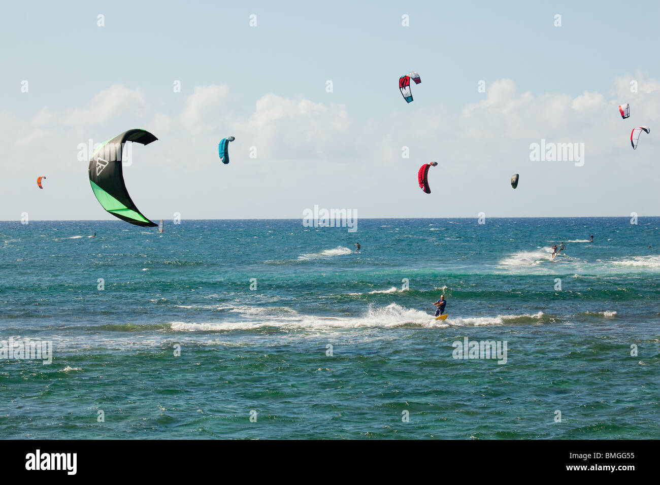 Kiteboarders riding the wind and ocean waves Stock Photo - Alamy