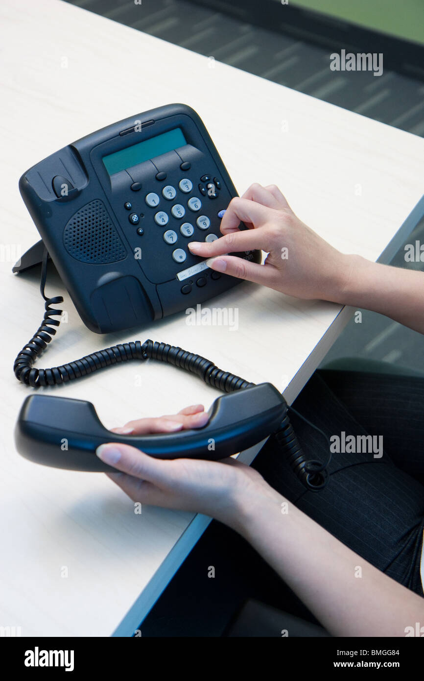 female making dialing phone call office Stock Photo - Alamy