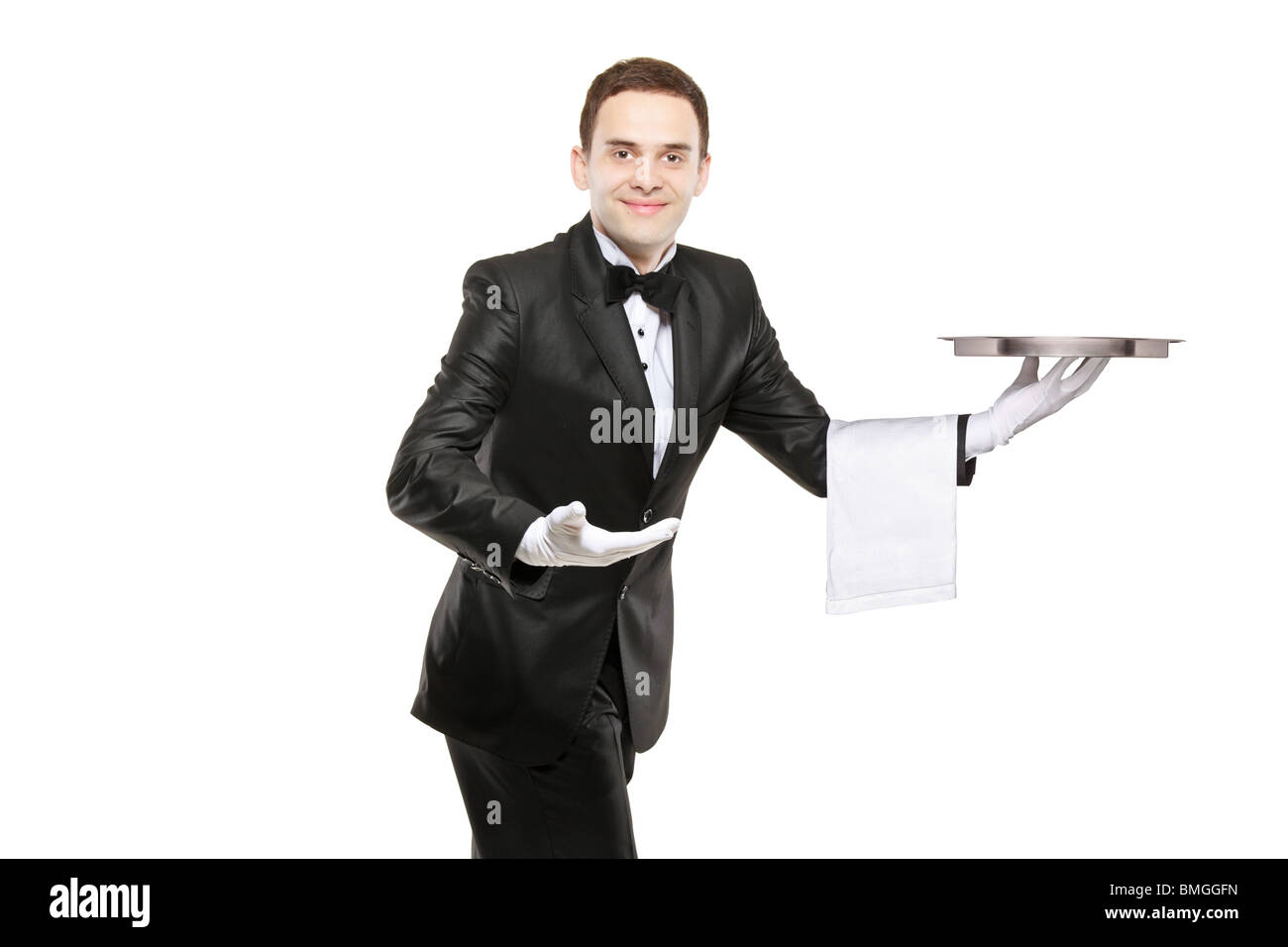 A young butler carrying an empty tray Stock Photo - Alamy