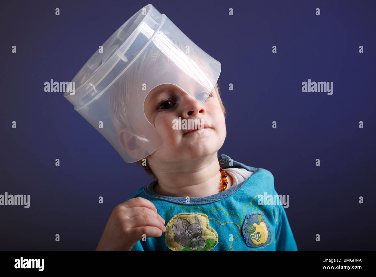 boy playing with plastic bucket Stock Photo - Alamy
