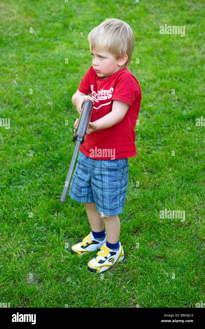 Child blond boy playing with air gun Stock Photo - Alamy