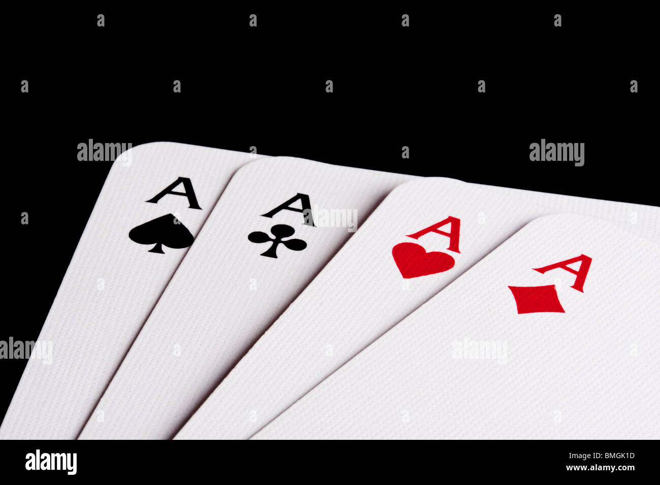 Four aces on black background Stock Photo - Alamy