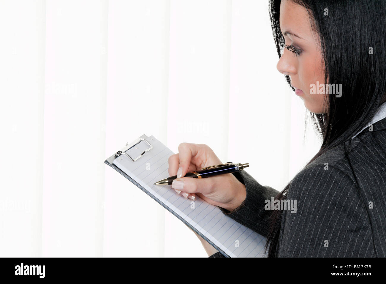 Manager with clipboard at controlling takes notes Stock Photo - Alamy