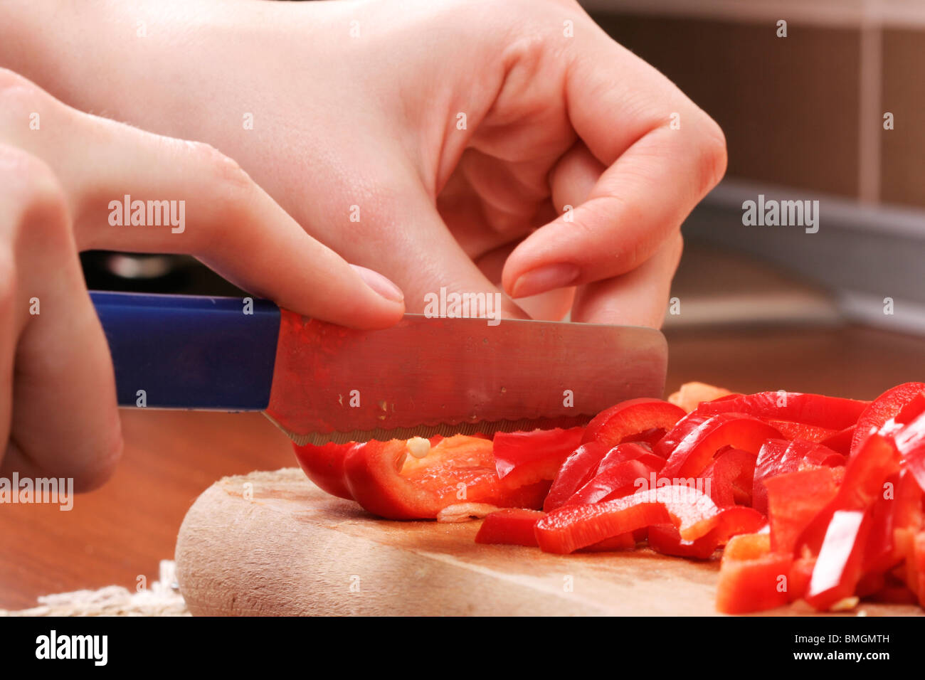 Chopping pepper with knife in small pieces Stock Photo - Alamy